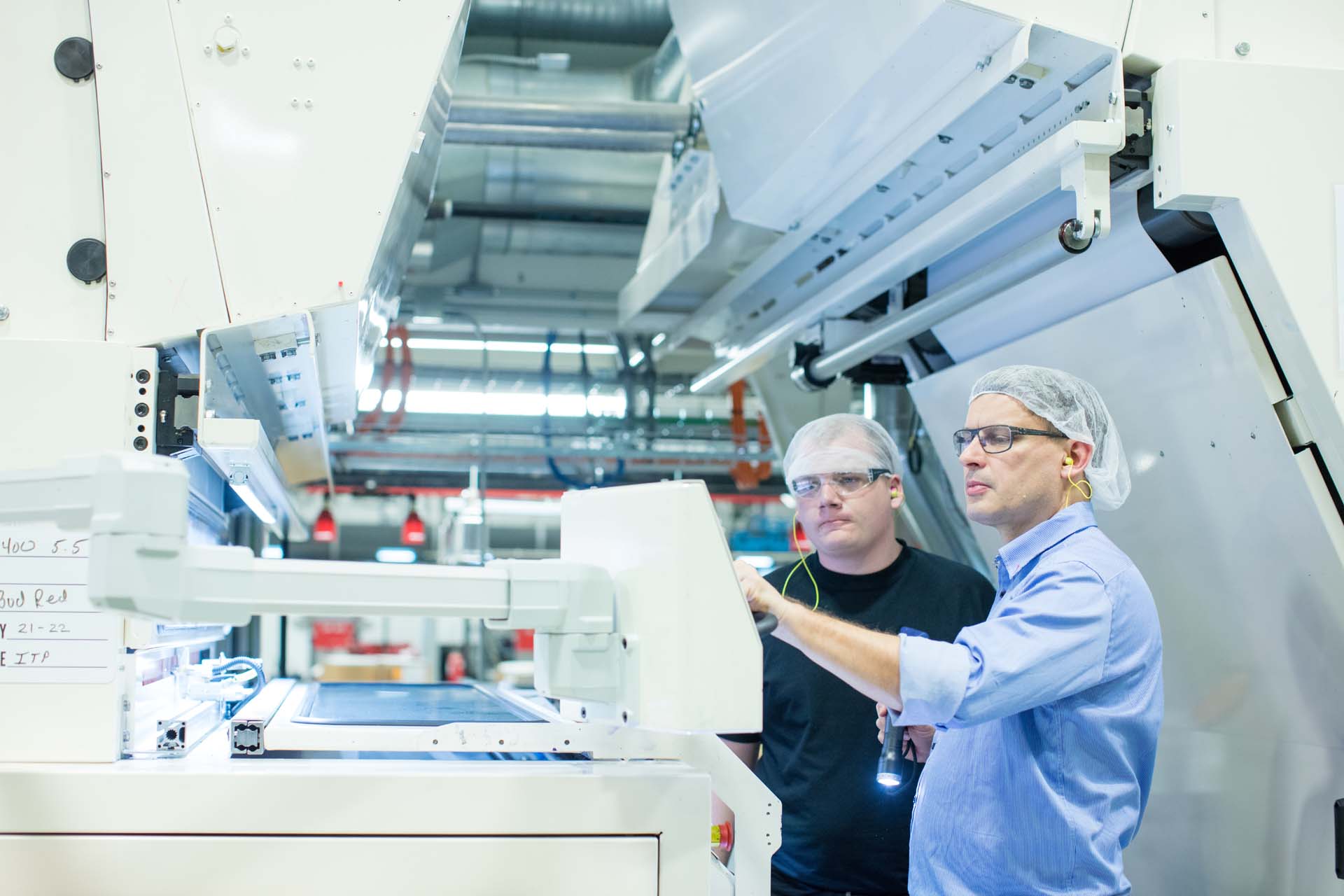 Workers Setting Up A New Line – Dominion Packaging, Inc.